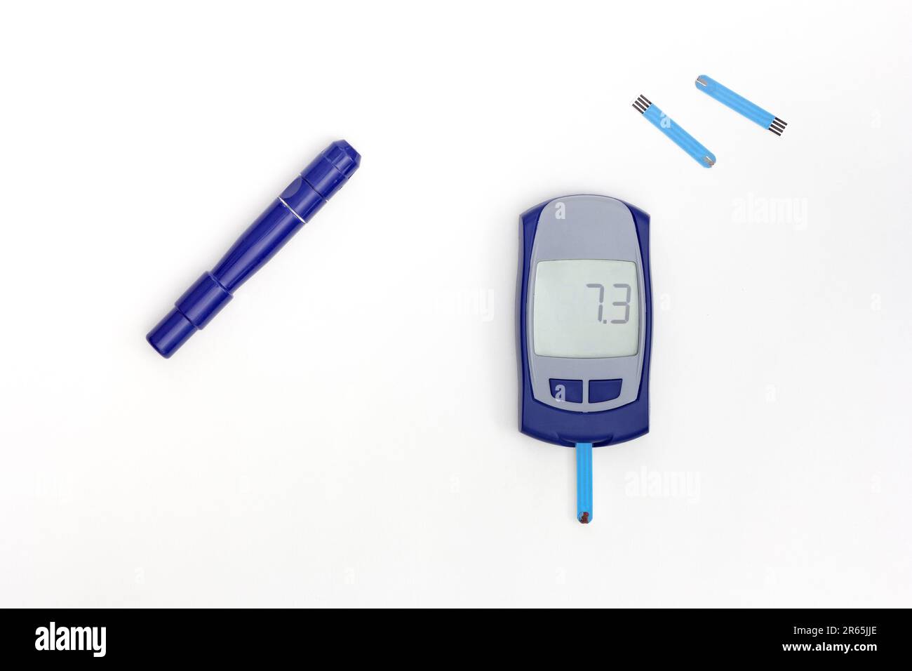 Top view of glucometer with 7.3 result on display with blooded test ...