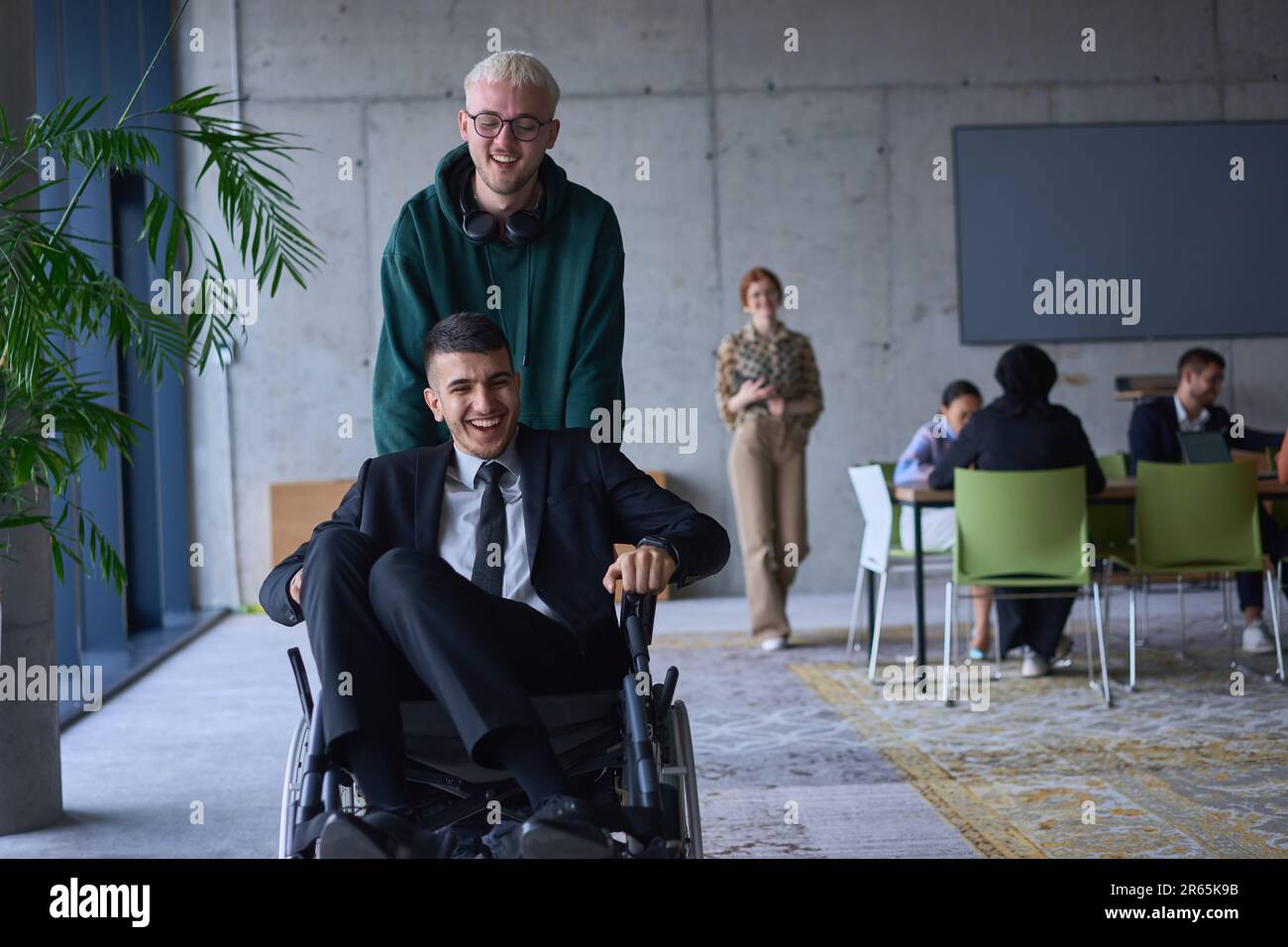 A young entrepreneur and his colleague, who is a person with a ...