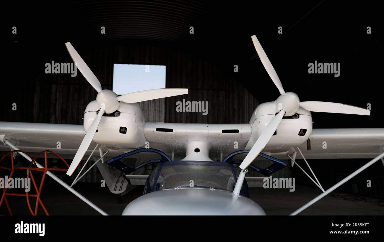 White private jet. Small white private jet parked in the hangar. An ...