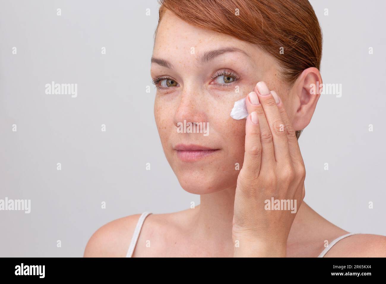 Portrait of cropped caucasian middle aged woman face with freckles and ...