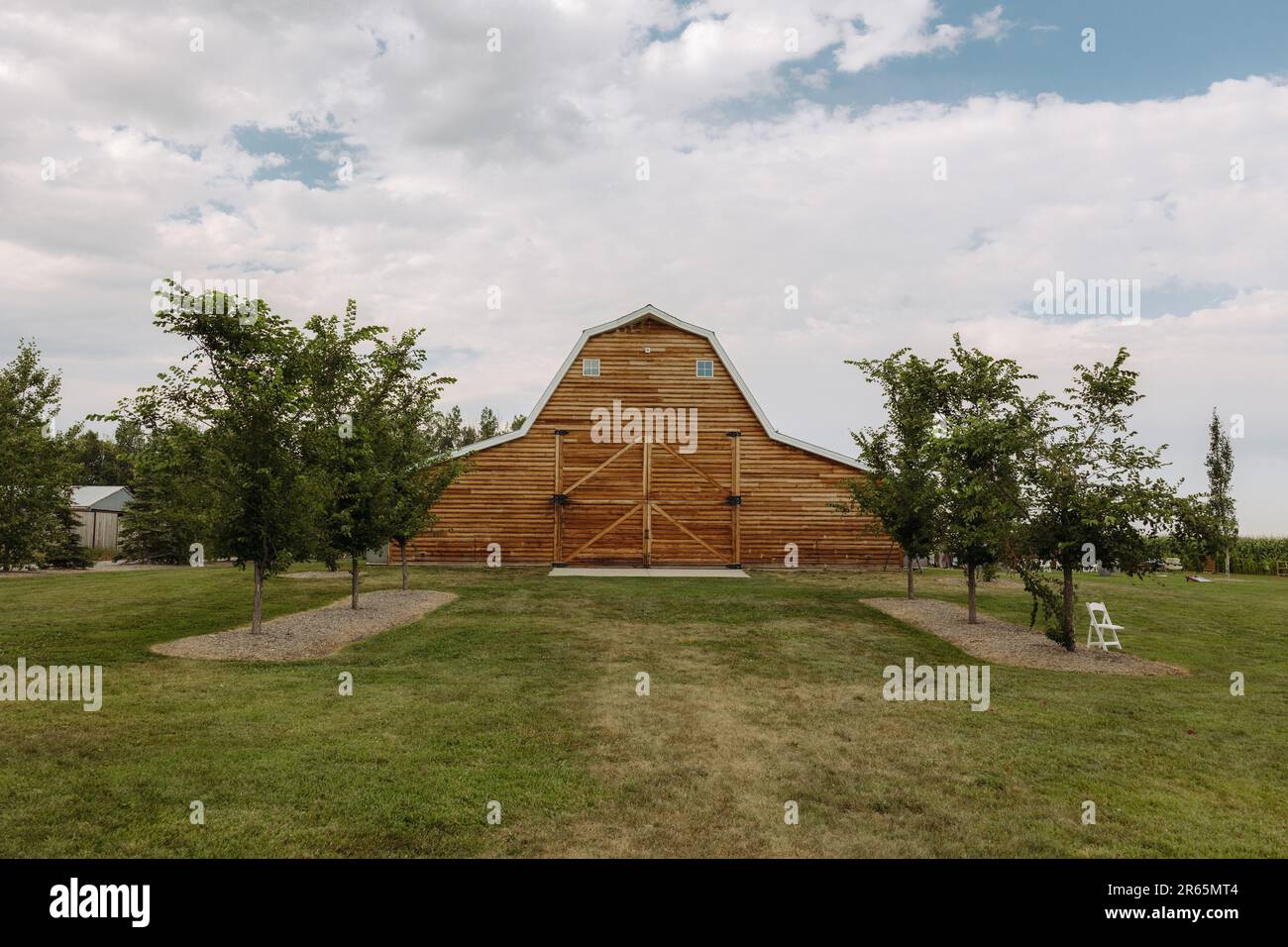 A traditional barn structure surrounded by an abundance of orchard ...
