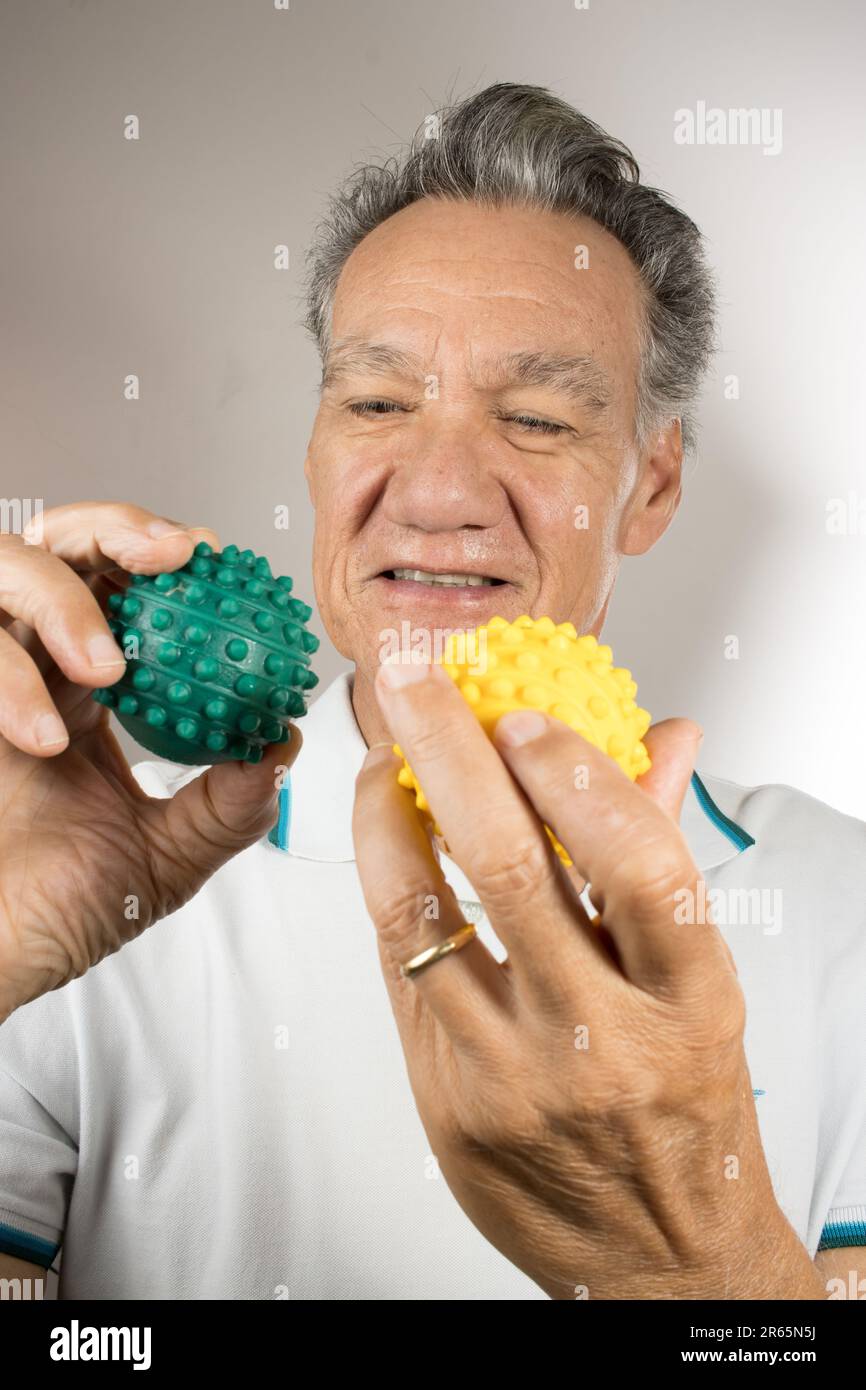 Mature man holding and squeezing massage therapy spike balls Stock ...