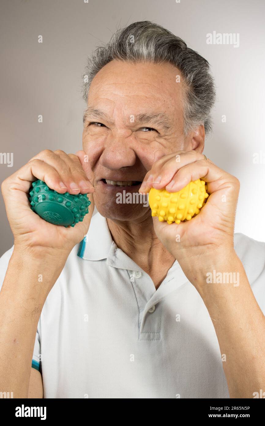 Mature man holding and squeezing massage therapy spike balls Stock ...