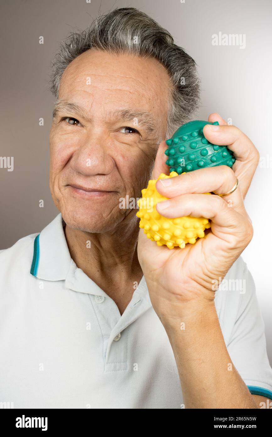 Mature man holding and squeezing massage therapy spike balls Stock ...