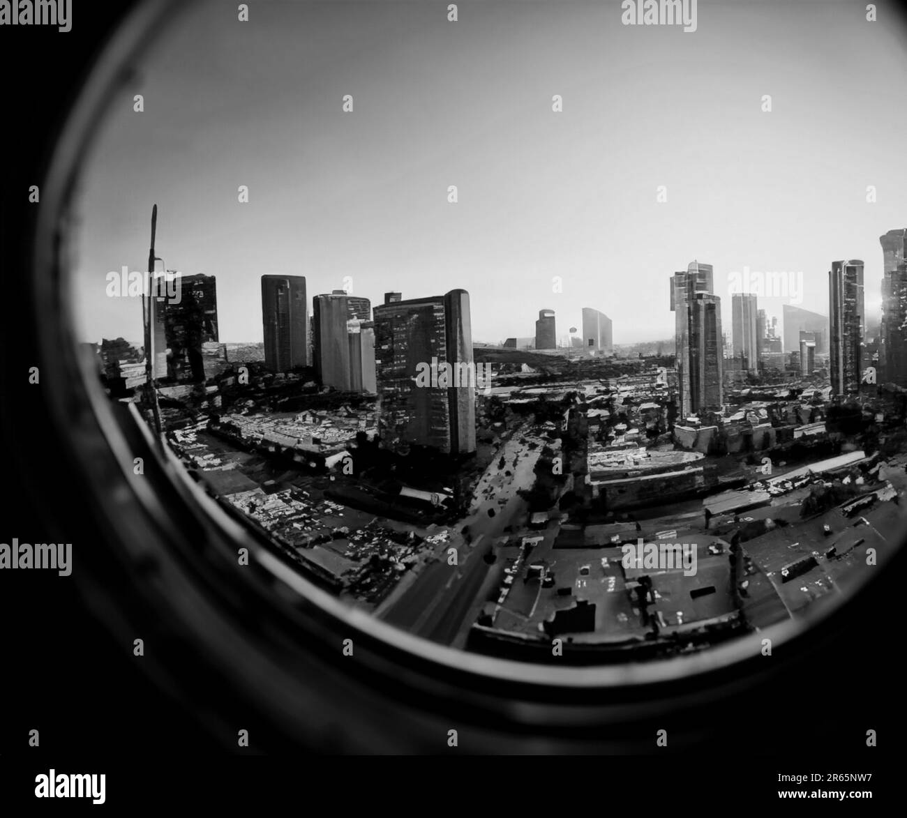 A circular window in a quaint room offers an expansive view of a ...