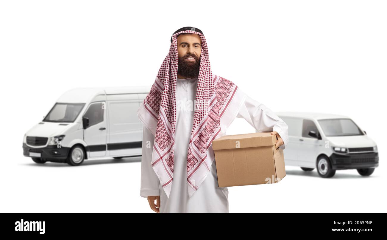 Saudi arab man in a thobe holding a cardboard box in front of vans ...