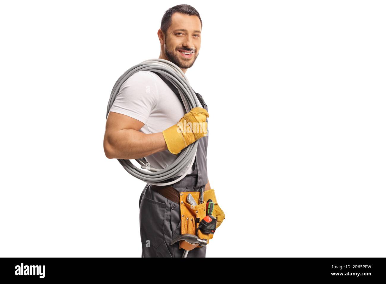 Electrician holding cables on his shoulder and smiling isolated on ...