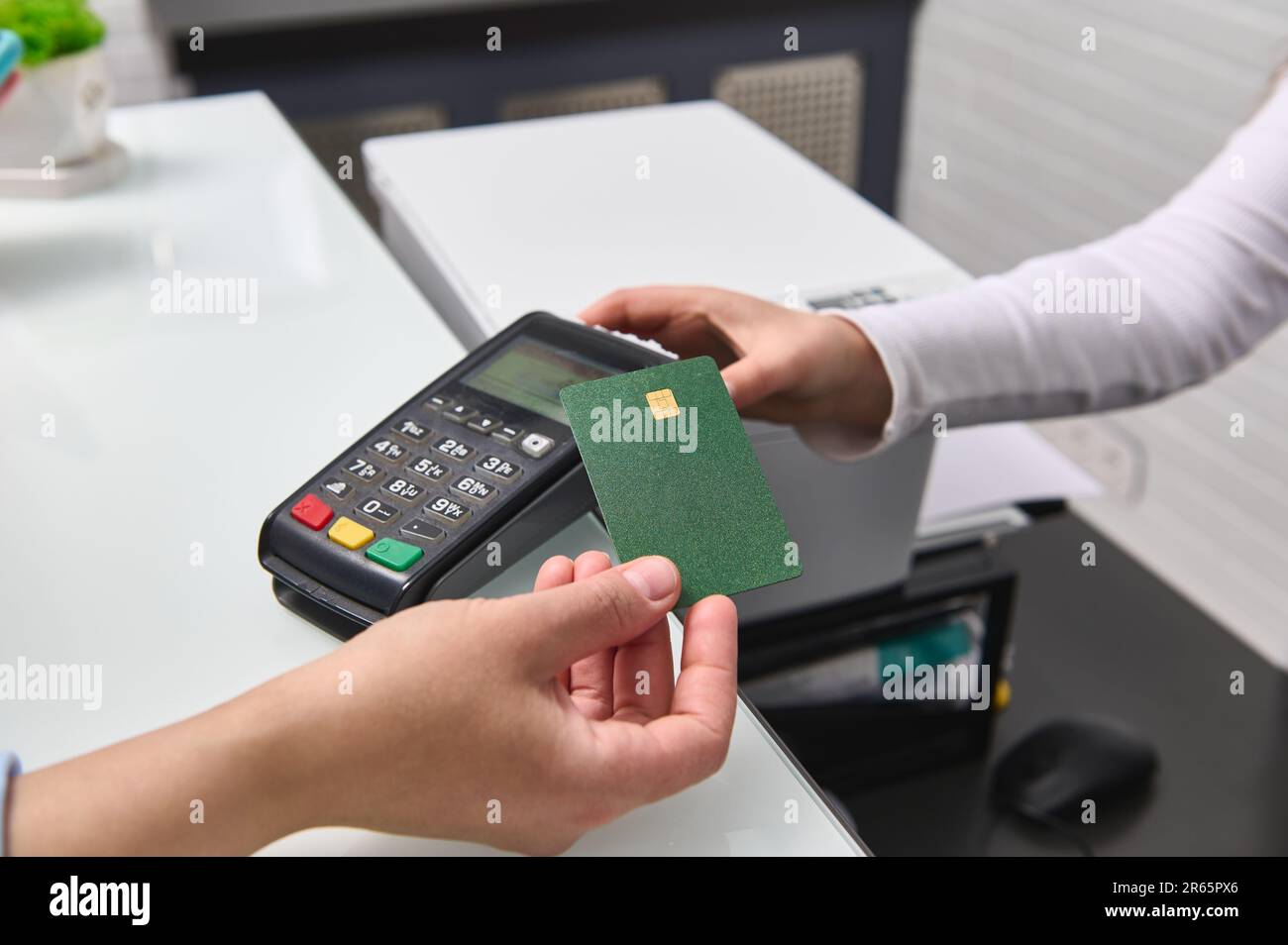 Selective focus. Closeup customer holds credit card over pos terminal ...