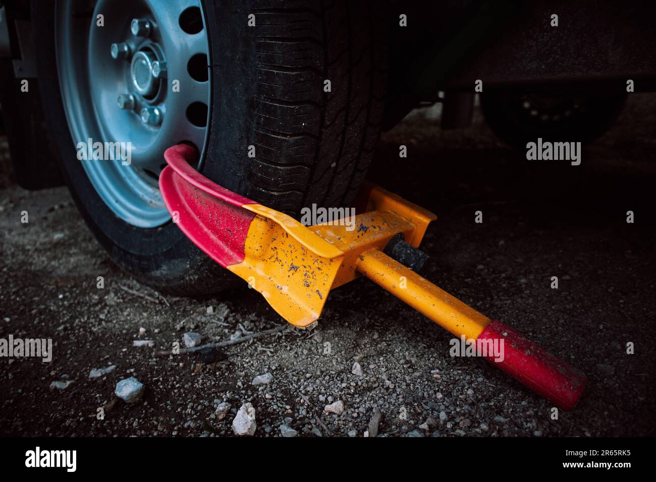 A clamp is used to secure a front wheel of the automobile during ...