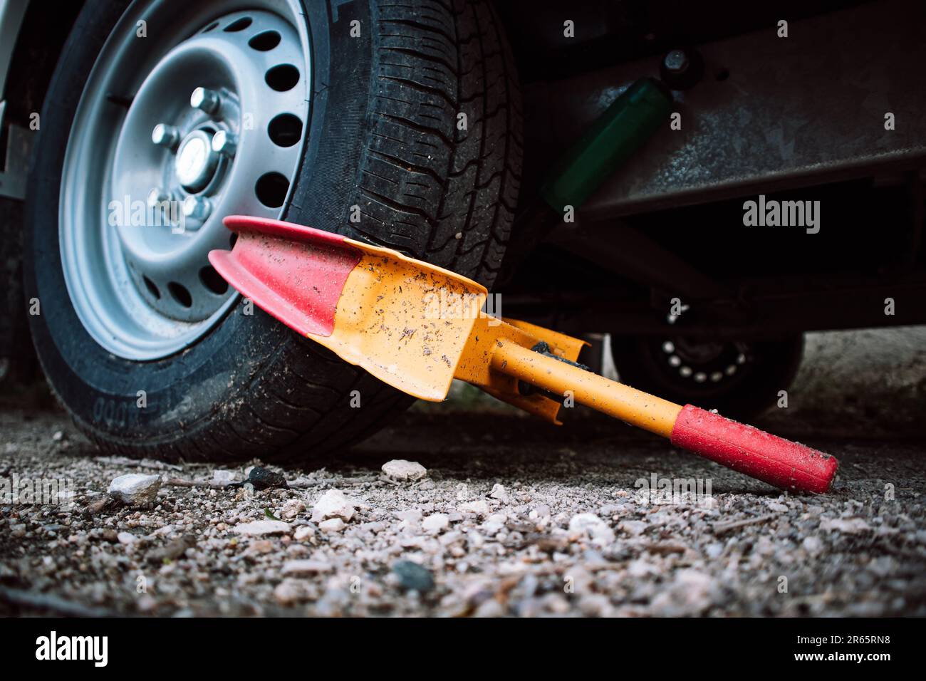 A clamp is used to secure a front wheel of the automobile during ...