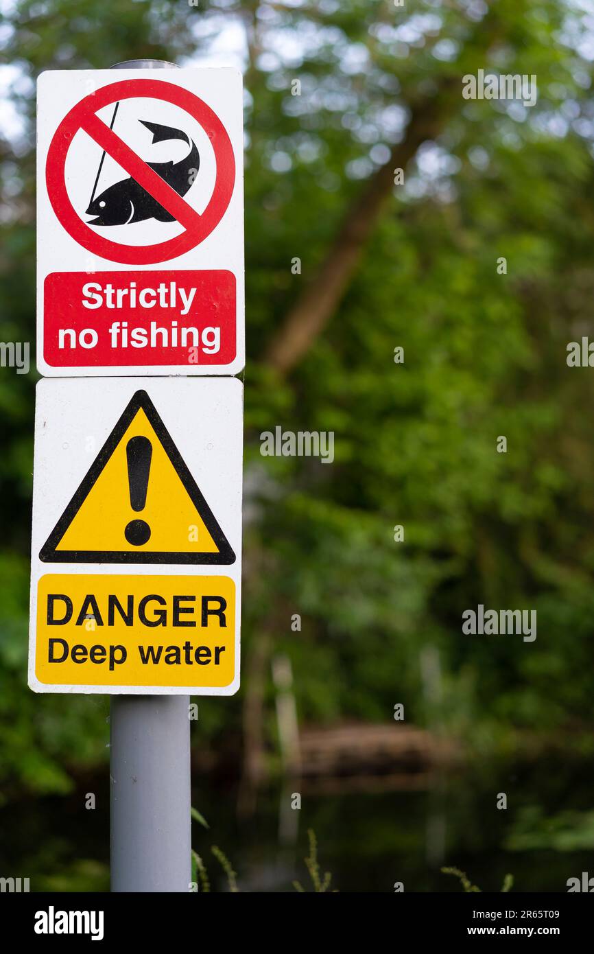 Strictly no fishing sign on a post with a danger deep water sign Stock ...