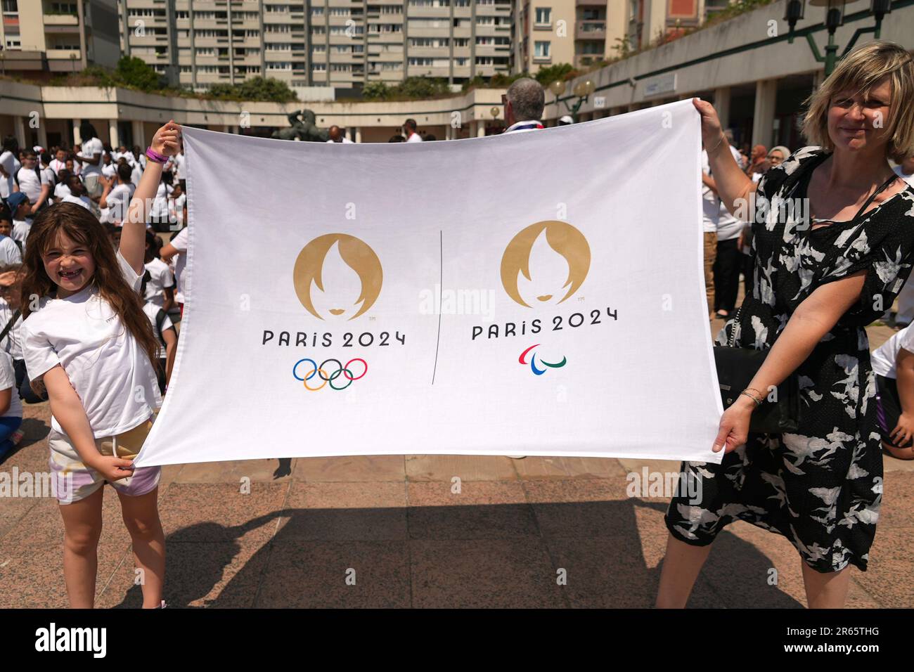 People display the logos of the Paris 2024 Olympic and Paralympic Games ...
