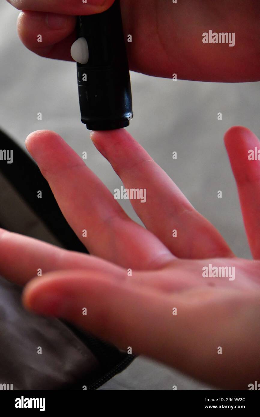 Peille, France. 03rd June, 2023. A young diabetic woman injects herself ...