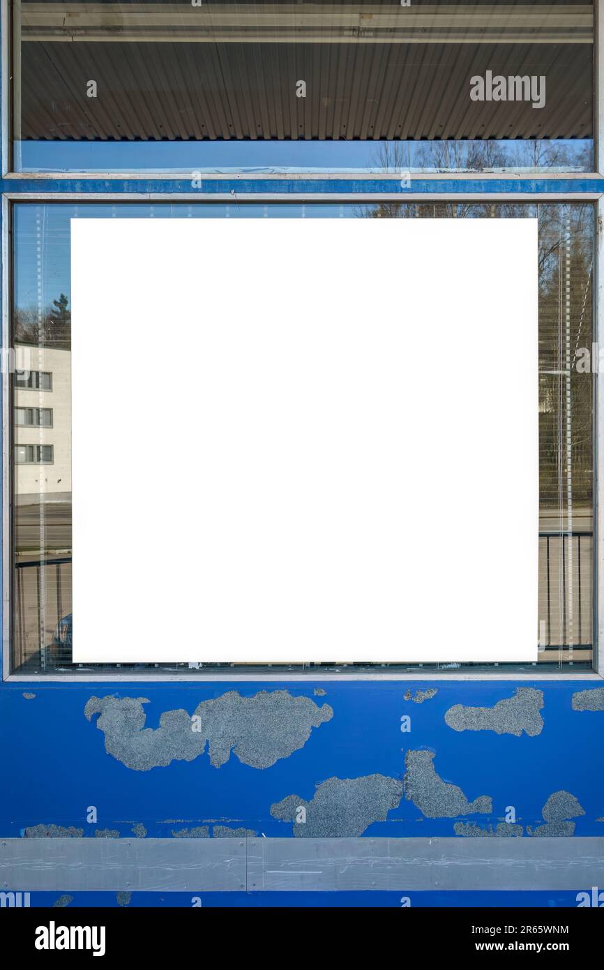 Empty white billboard on the window of an industrial building, blank ...