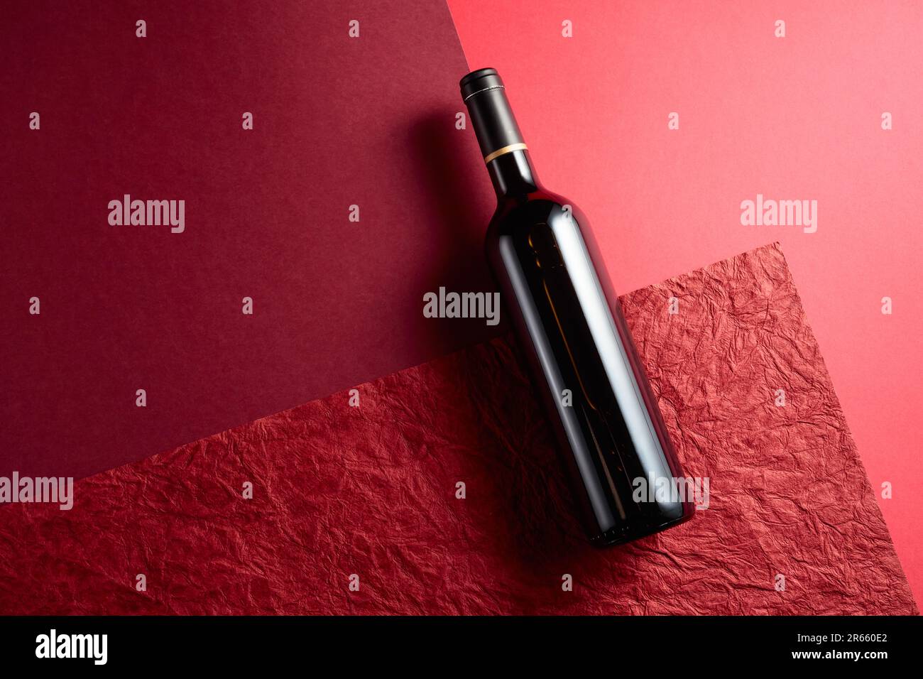 Bottle of red wine on a red background.Red background with different ...