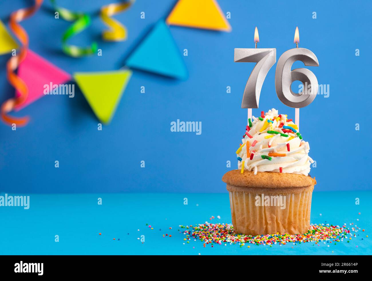 Candle number 76 - Cake birthday in blue background Stock Photo - Alamy