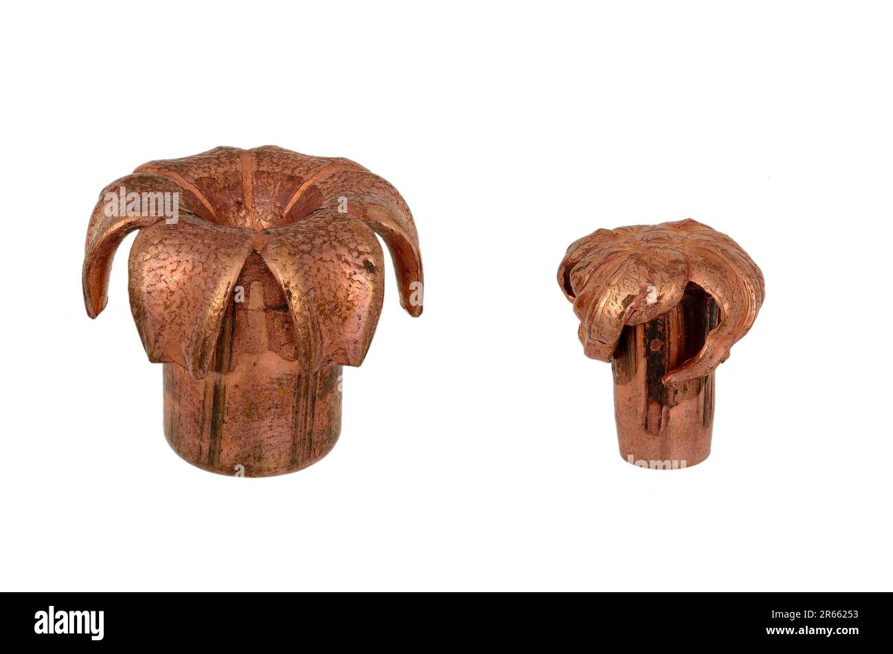 An isolated image of two broken copper bullets, one larger than the ...
