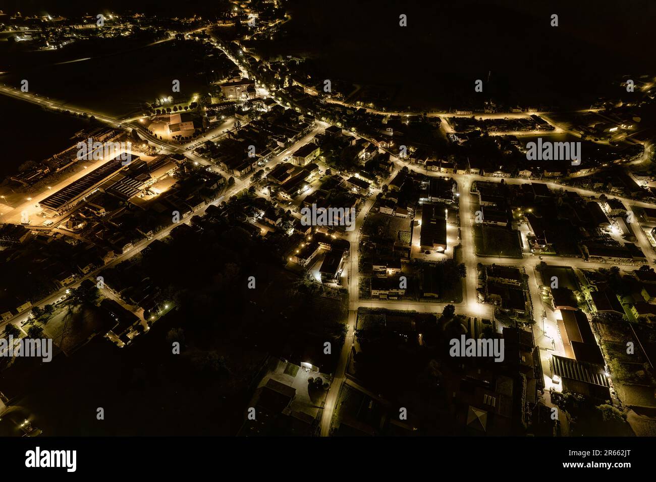 Aerial view of a town at night, with street lights creating an ...