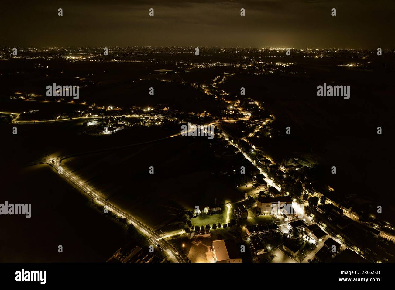 Aerial view of a town at night, with street lights creating an ...