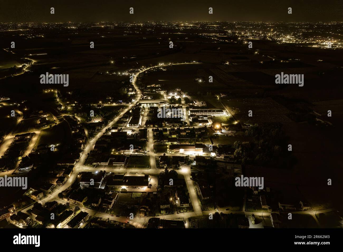 Aerial view of a town at night, with street lights creating an ...
