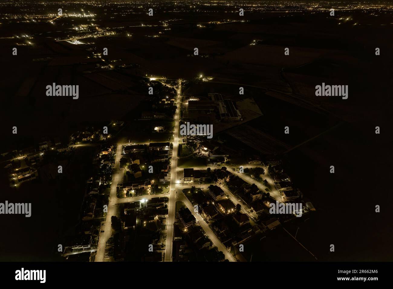 Aerial view of a town at night, with street lights creating an ...