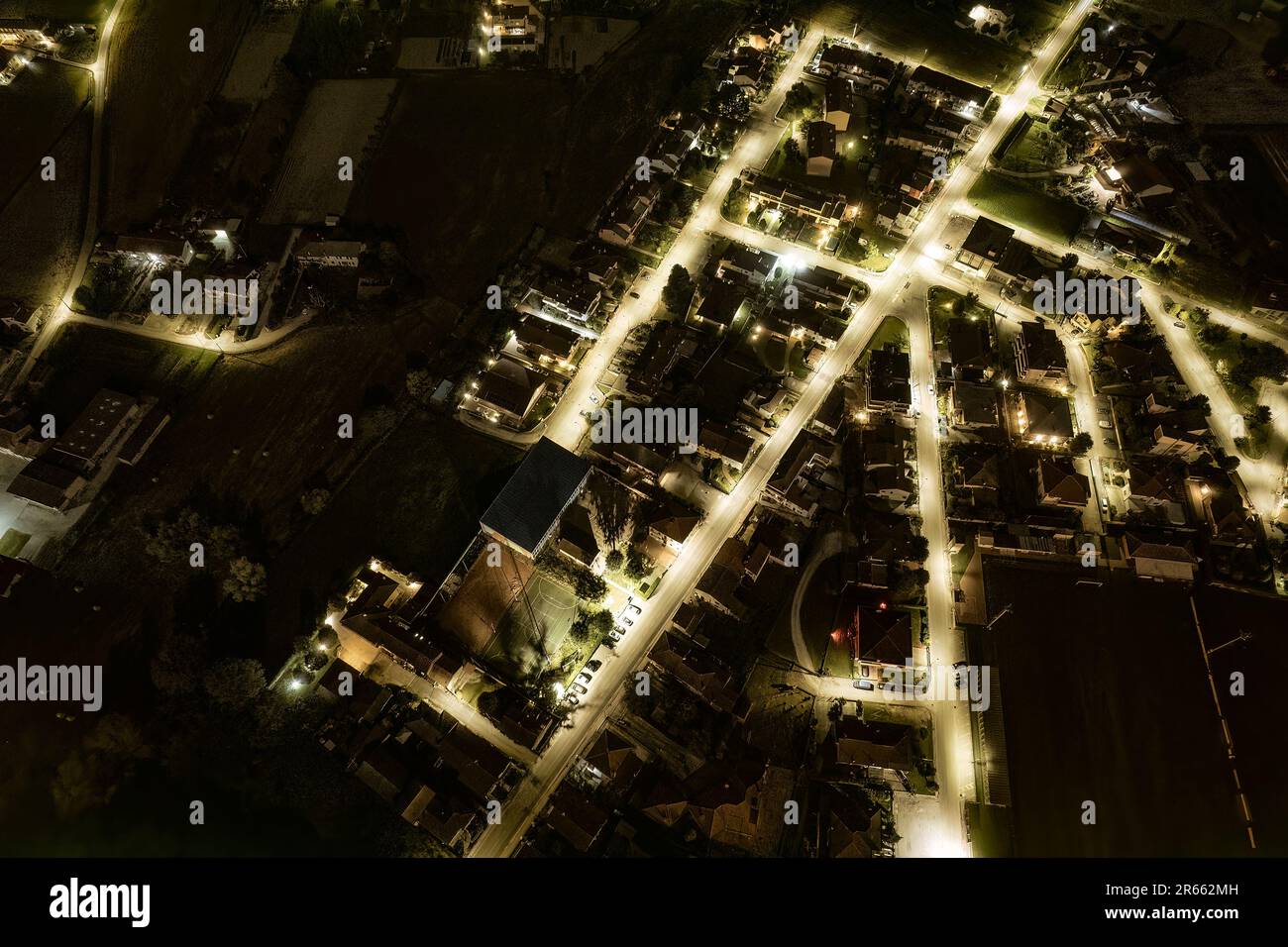 Aerial view of a town at night, with street lights creating an ...