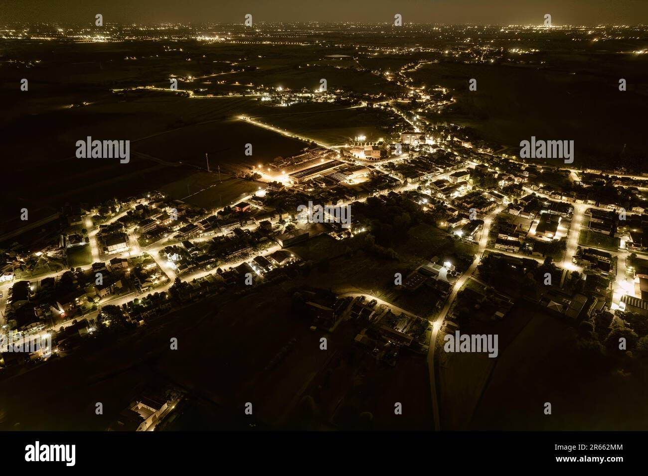 Aerial view of a town at night, with street lights creating an ...