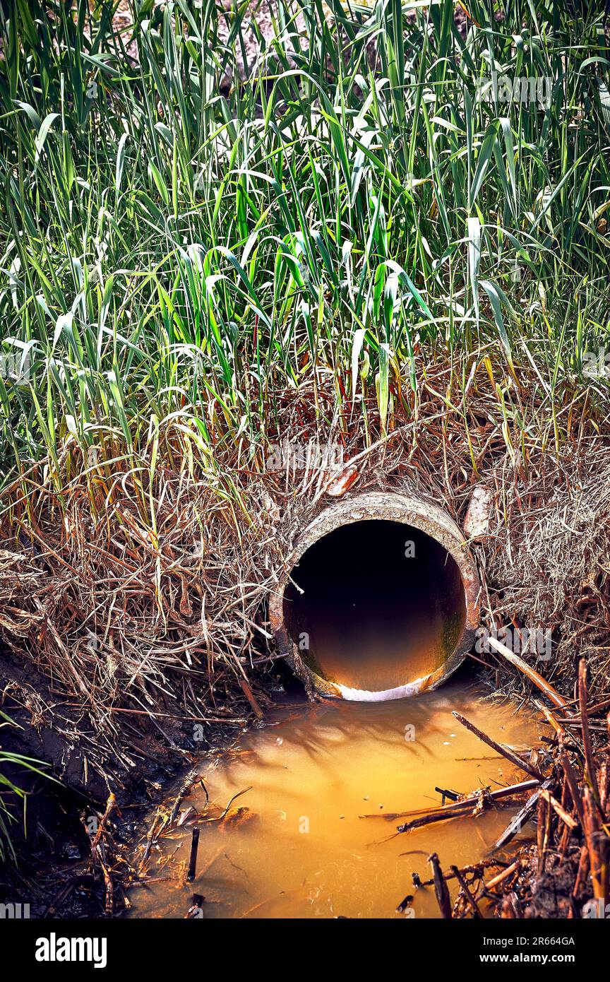 Rusty old outflow pipe in rural setting Stock Photo - Alamy