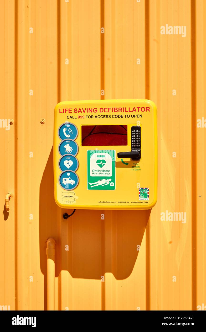 Life saving yellow defibrillator in box mounted on orange wall Stock ...