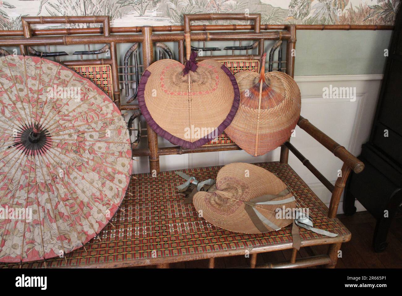 straw fans, umbrella and rattan bench inside a mansion in nohant-vic ...