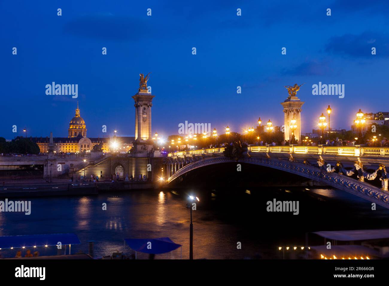 Pont Alexandre III Bridge and illuminated lamp posts at sunset with ...