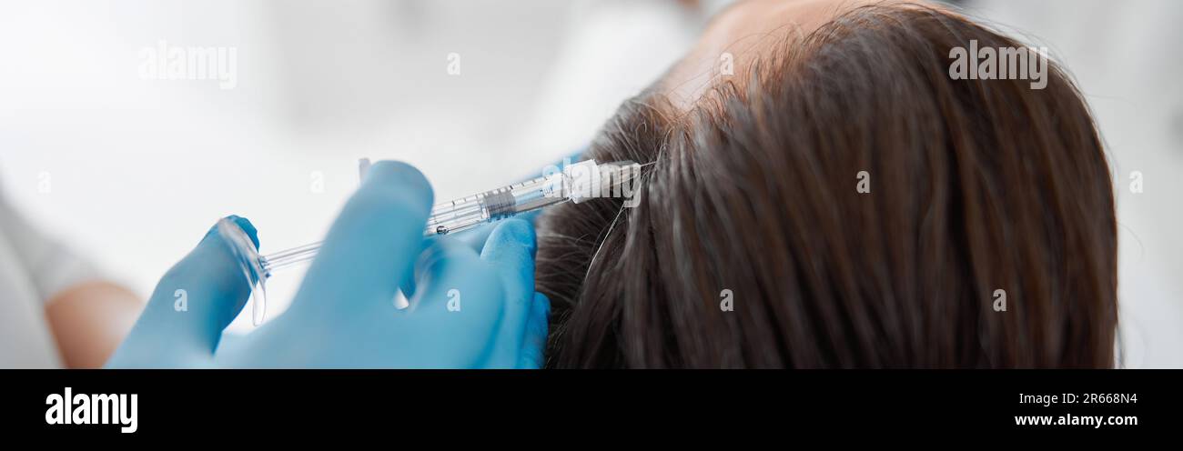 Specialist does injection in patient head skin during meso therapy ...