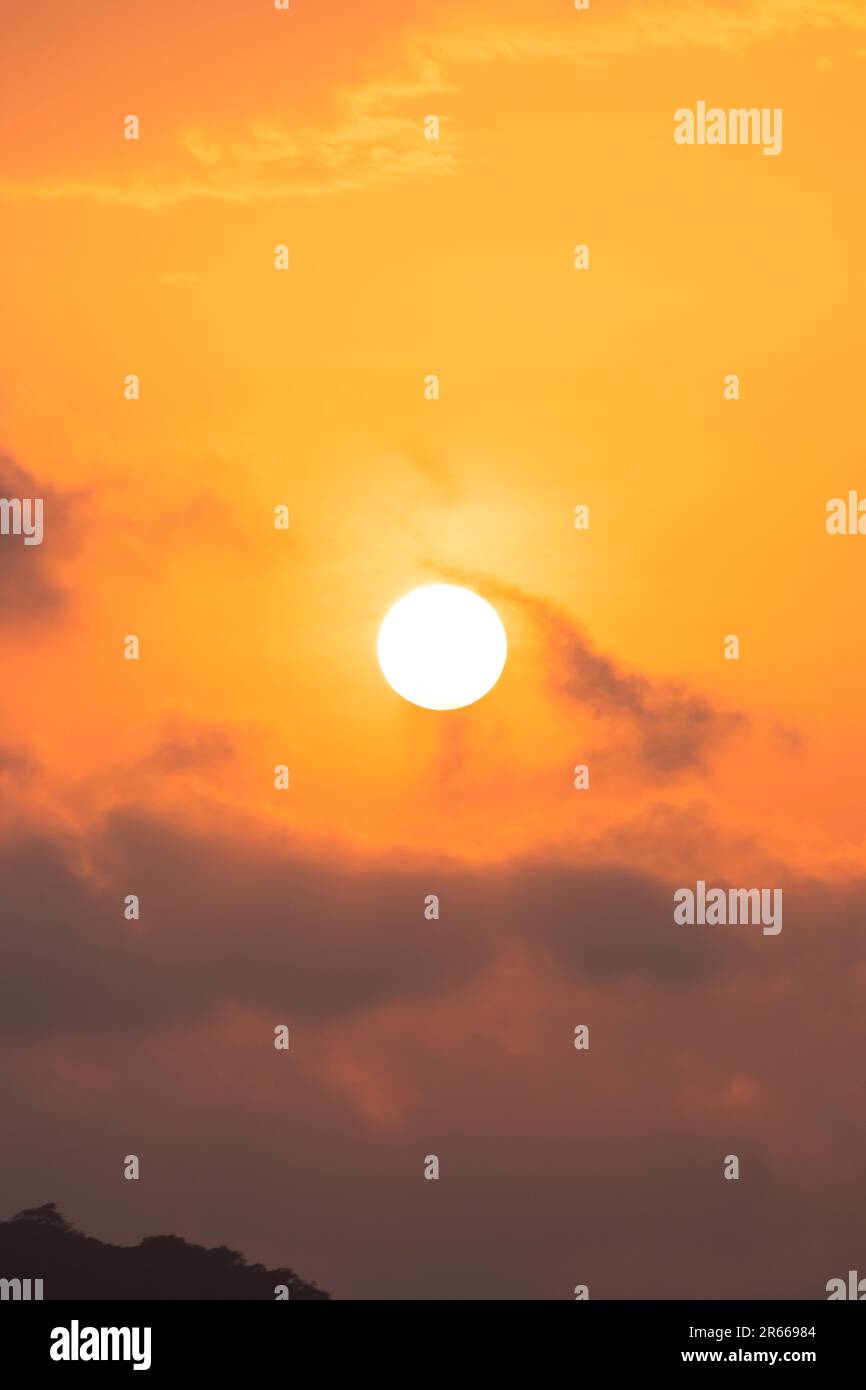 A breathtaking sunset paints the sky in vivid oranges and pinks ...