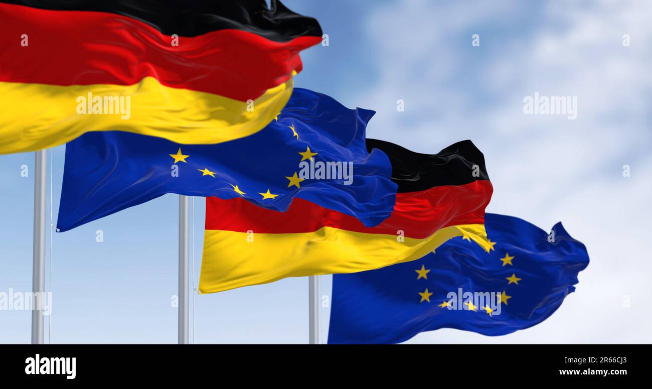 The flags of Germany and the European Union waving in the wind on a ...