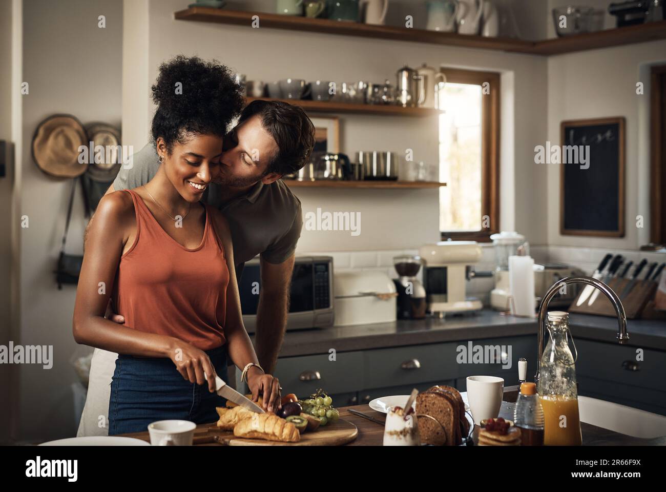 Young man kissing wife making hi-res stock photography and images - Alamy