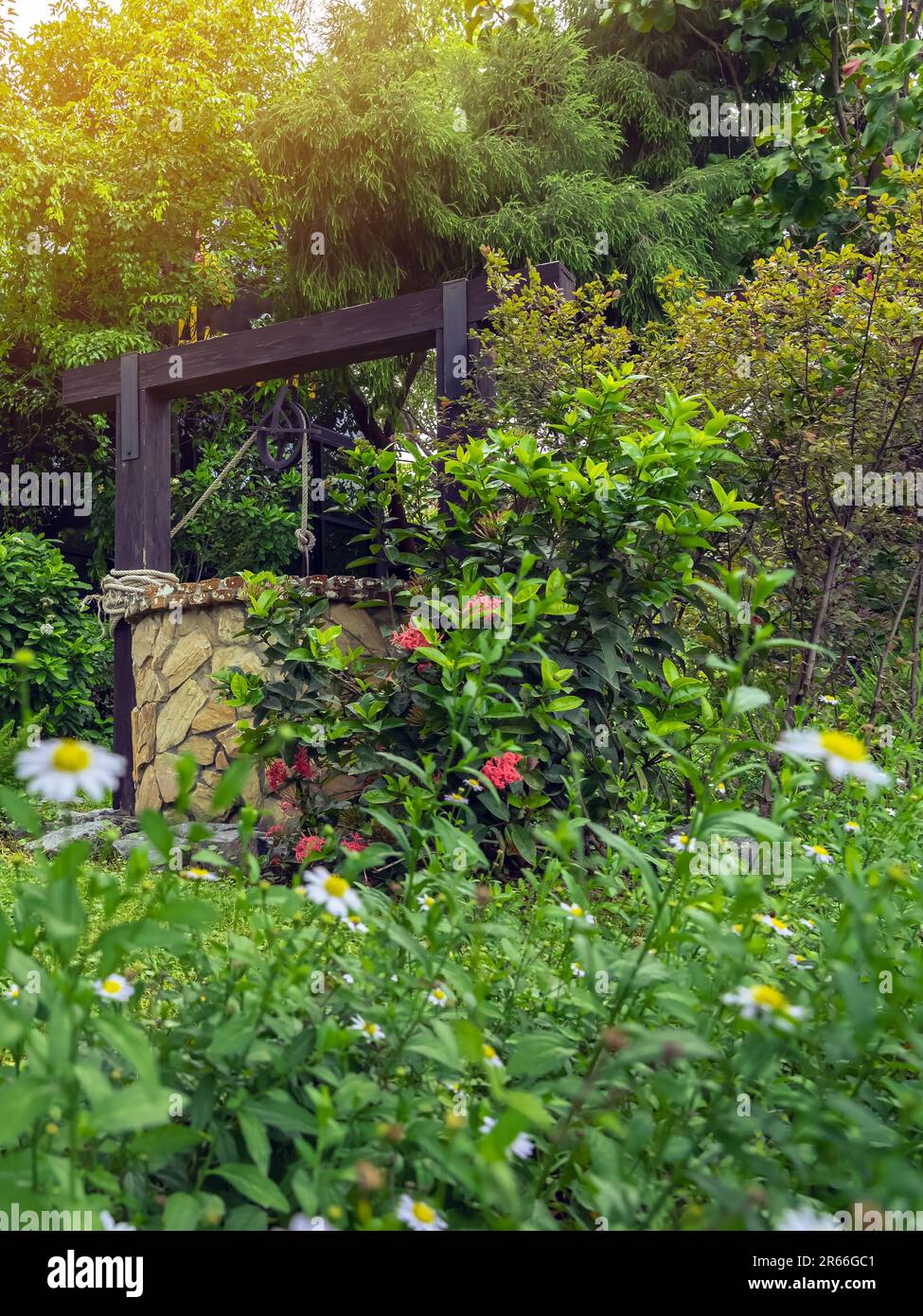 Beautiful artesian well made by stones and wheel pulley with metal ...