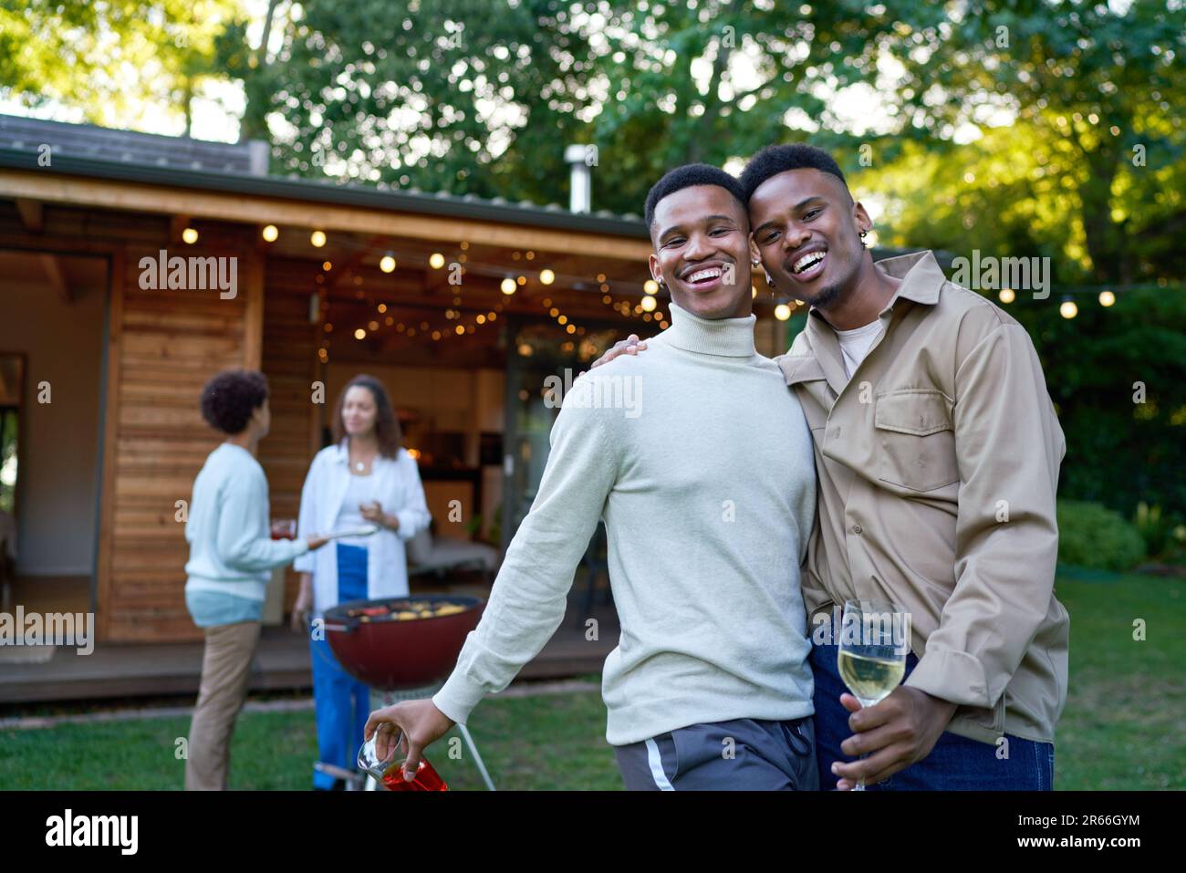 Portrait happy young gay male couple enjoying barbecue in backyard Stock Photo - Alamy