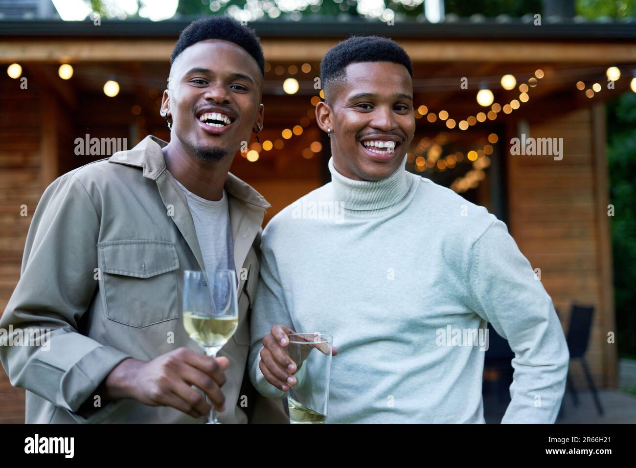 Portrait happy young gay male couple drinking in backyard Stock Photo - Alamy