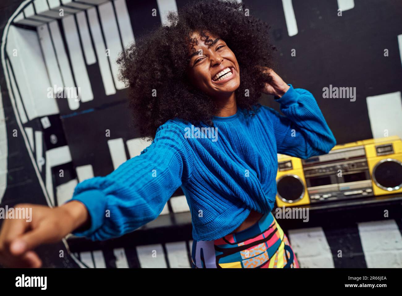 Portrait happy young woman dancing, listening to music Stock Photo - Alamy
