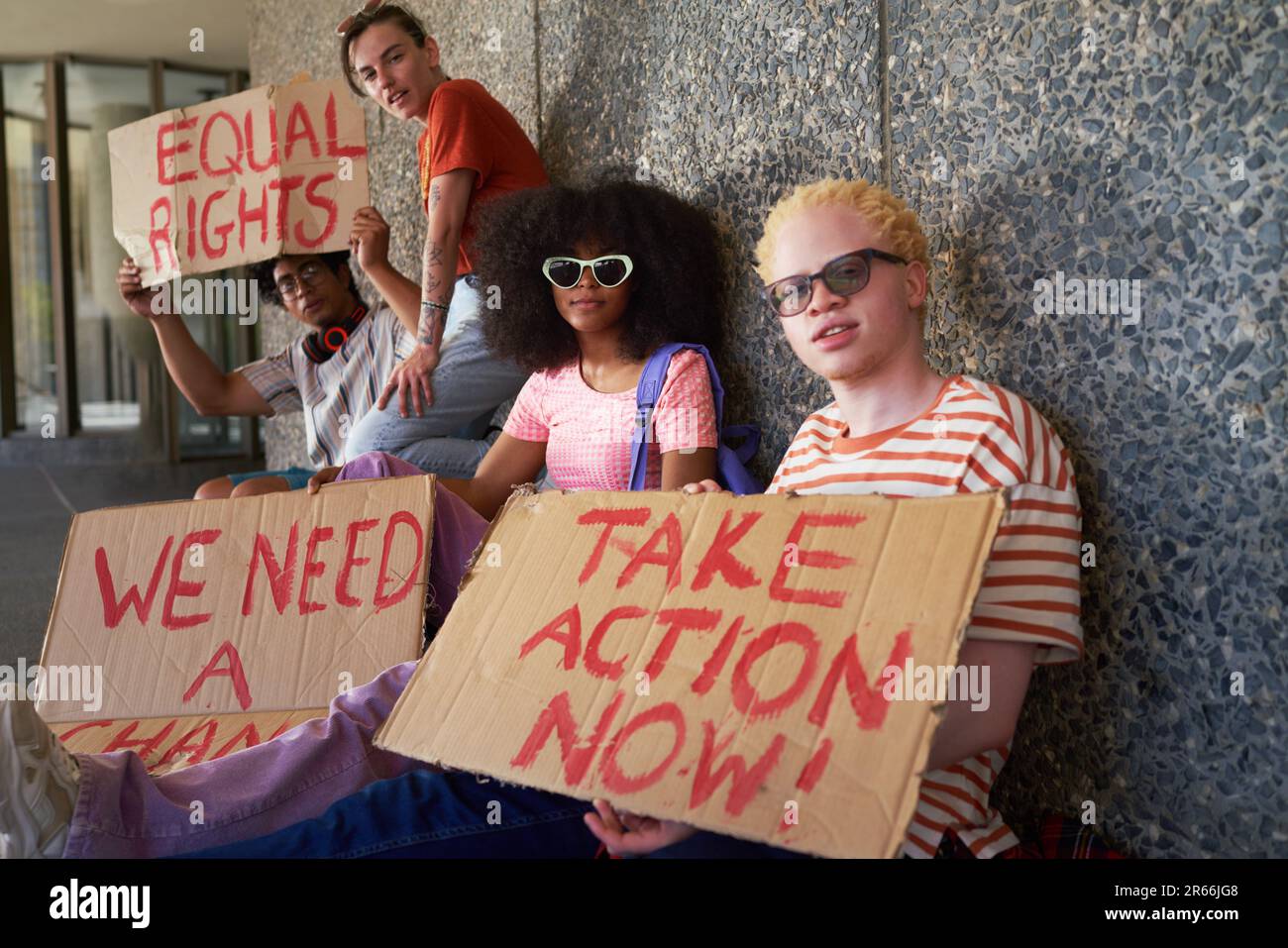 Portrait young friends holding equal rights signs at wall Stock Photo ...