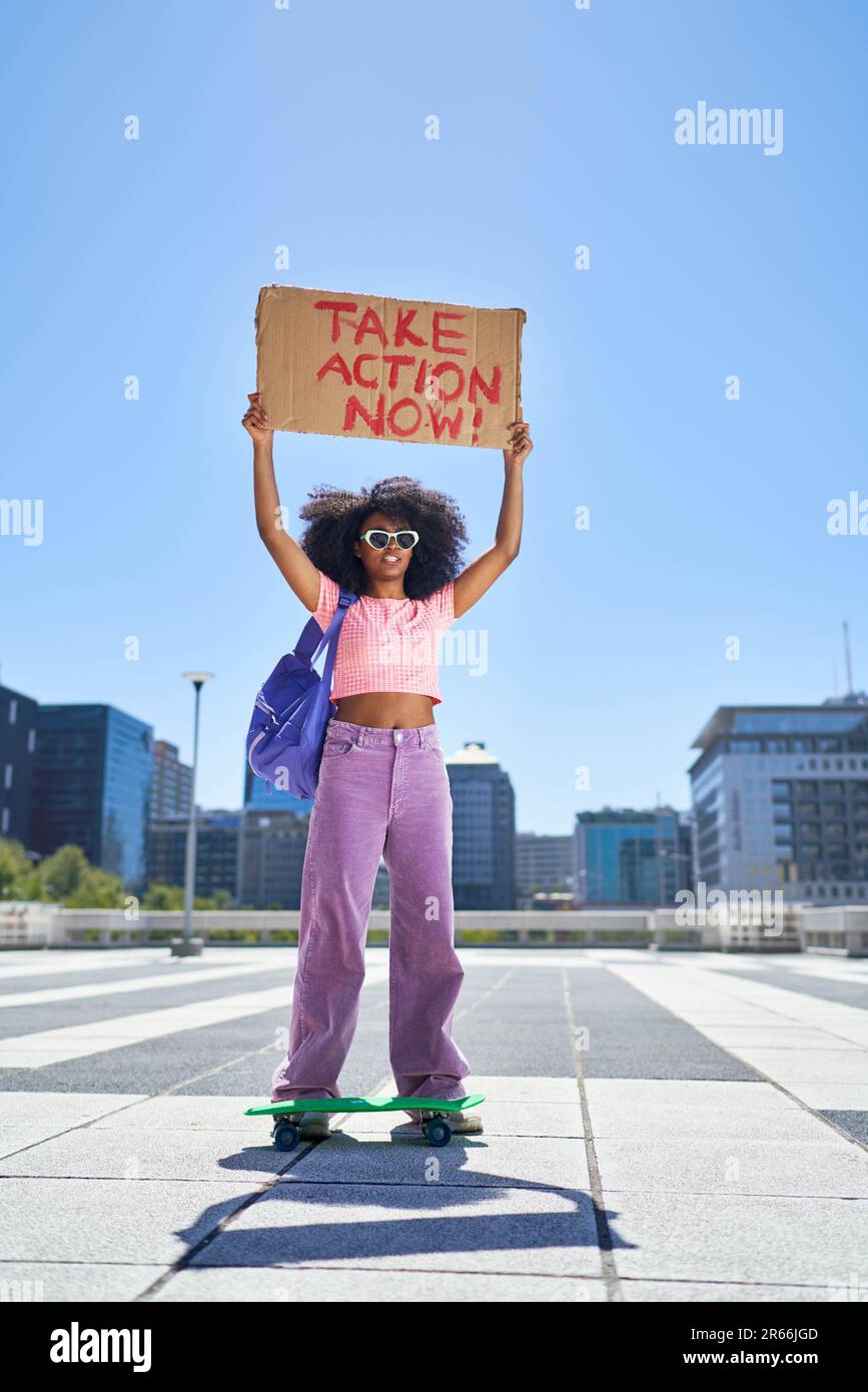 Portrait confident young female protester with sign in sunny city Stock ...