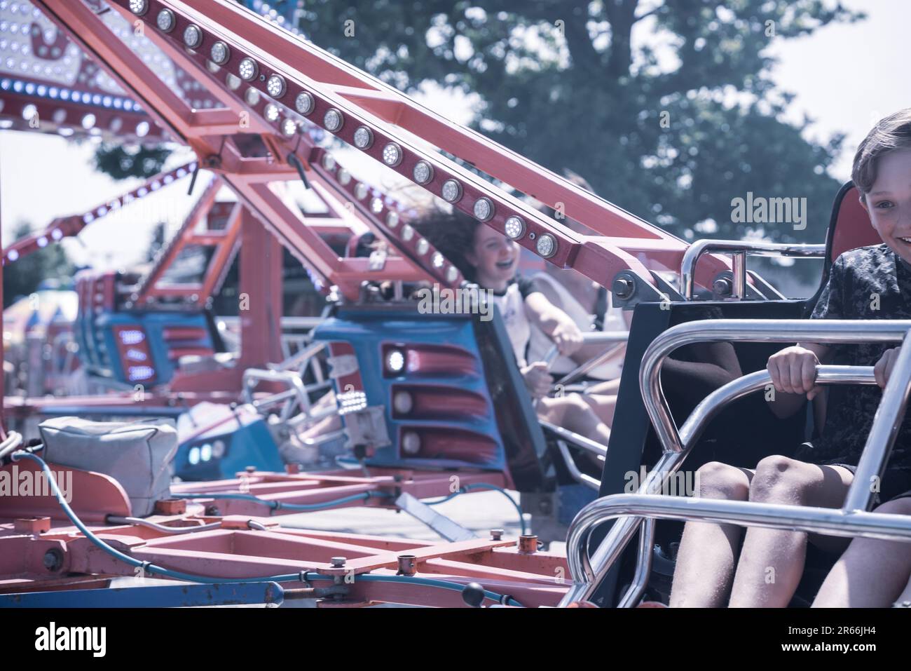 Children on a fun fair ride in England, UK Stock Photo - Alamy