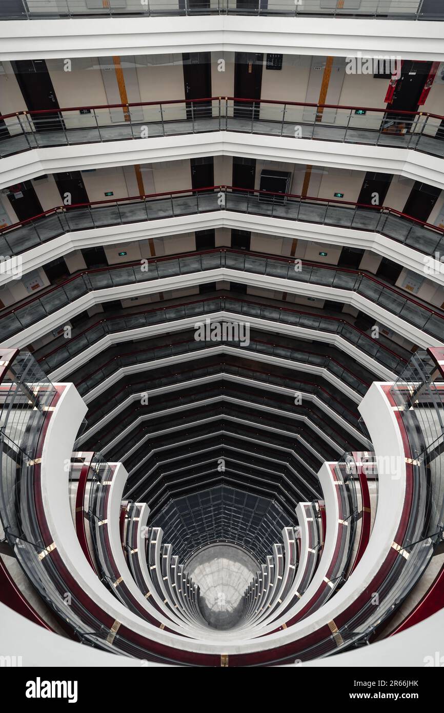 Inside a multi-leveled atrium of a large building, with a modern, sleek ...