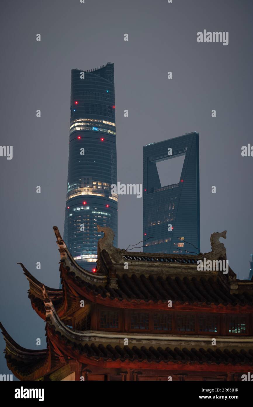 A vertical view of the Shanghai skyline illuminated with bright lights ...