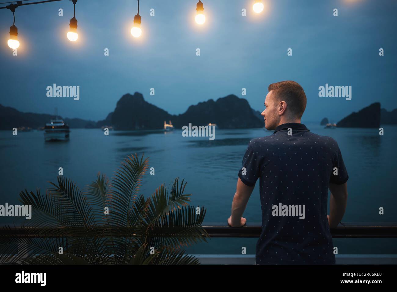 Man enjoying magnificent night view from cruise ship between islands ...