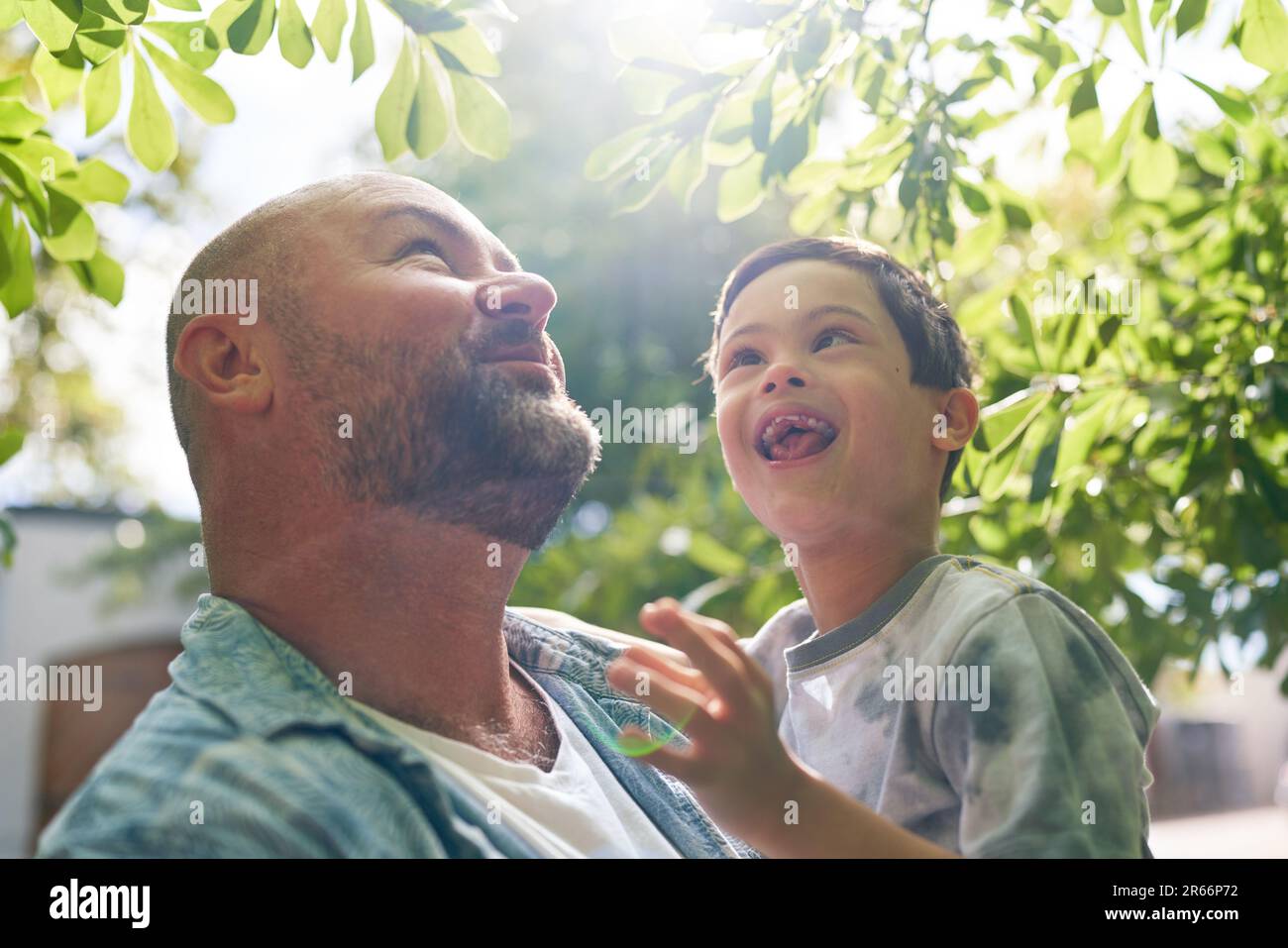 Close up happy father and son with Down Syndrome below tree Stock Photo ...