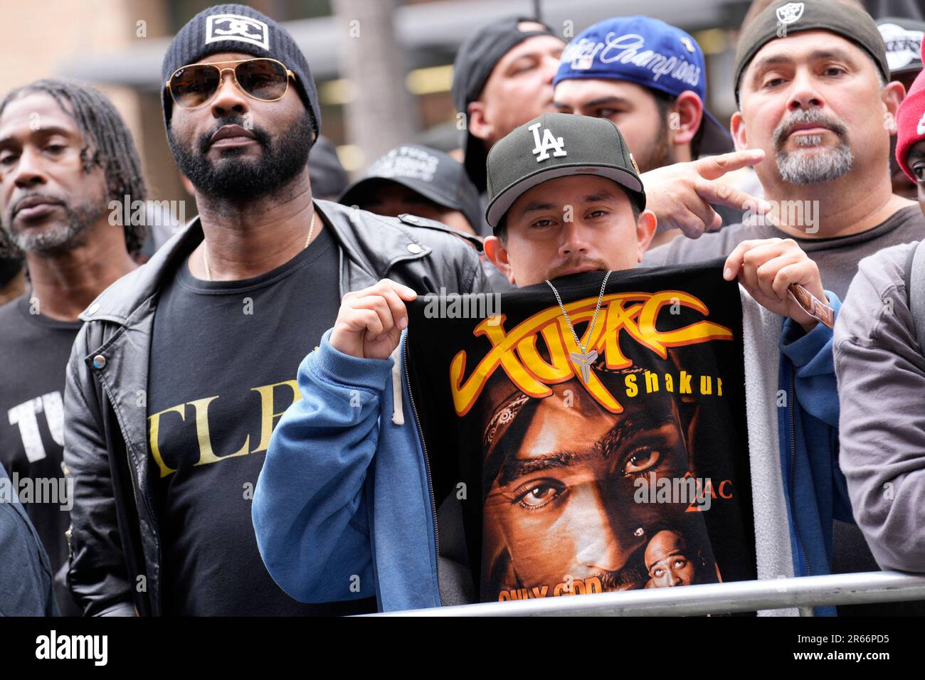 A fan shows off a shirt with an image of the late rapper and actor ...