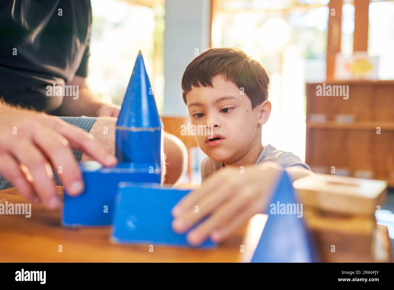 Father and son with Down Syndrome playing with blue block toys Stock ...
