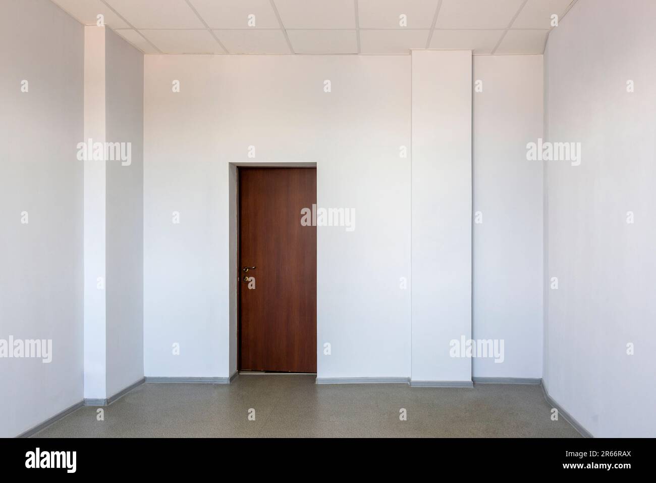 Interior of an empty room with a closed door Stock Photo - Alamy