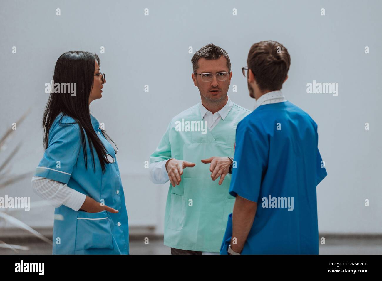 A nurse, medical technician, and doctor engage in a discussion on ...